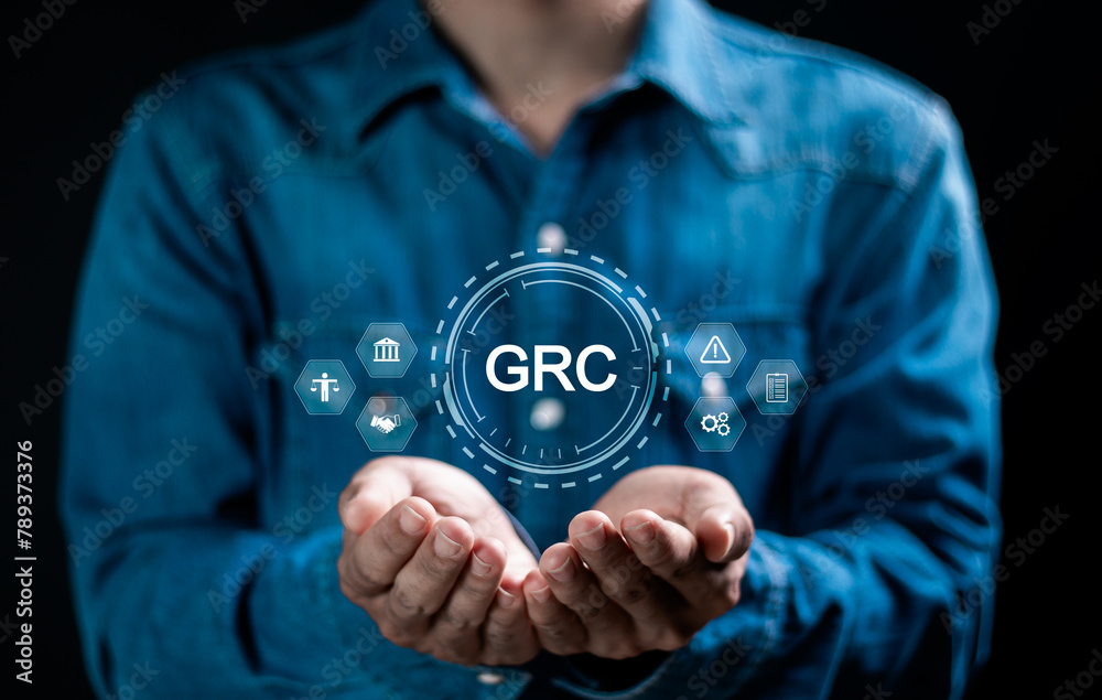 GRC, Governance Risk and Compliance concept. Businessman holding GRC ...