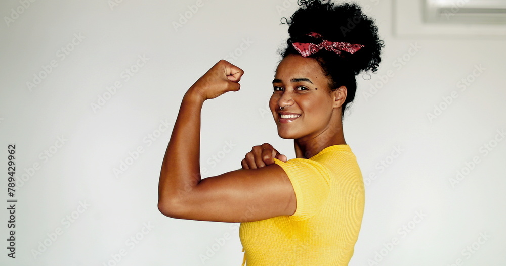 Happy Confident young African American woman showing strength, flexing ...