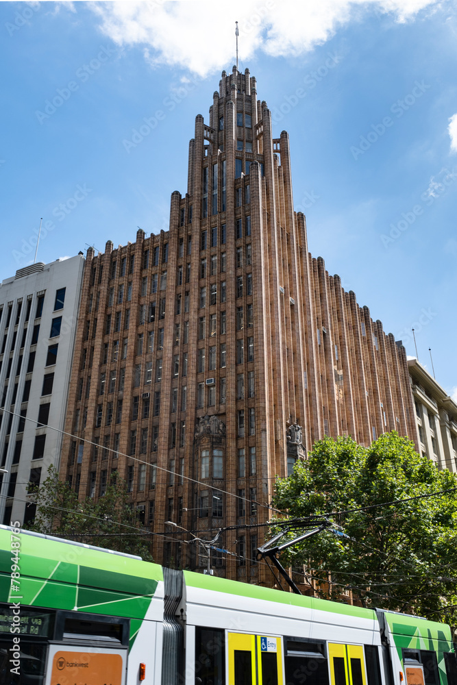 Tram passes the Manchester Unity Building, an art deco-inspired ...