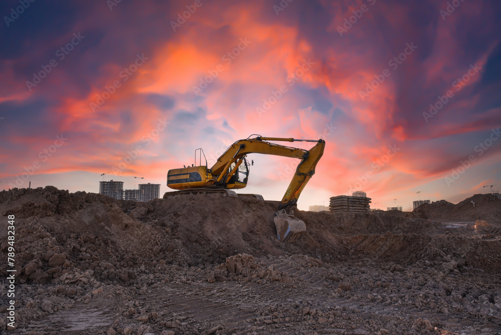 Excavator on earthmoving. Backhoe dig ground on construction site on ...