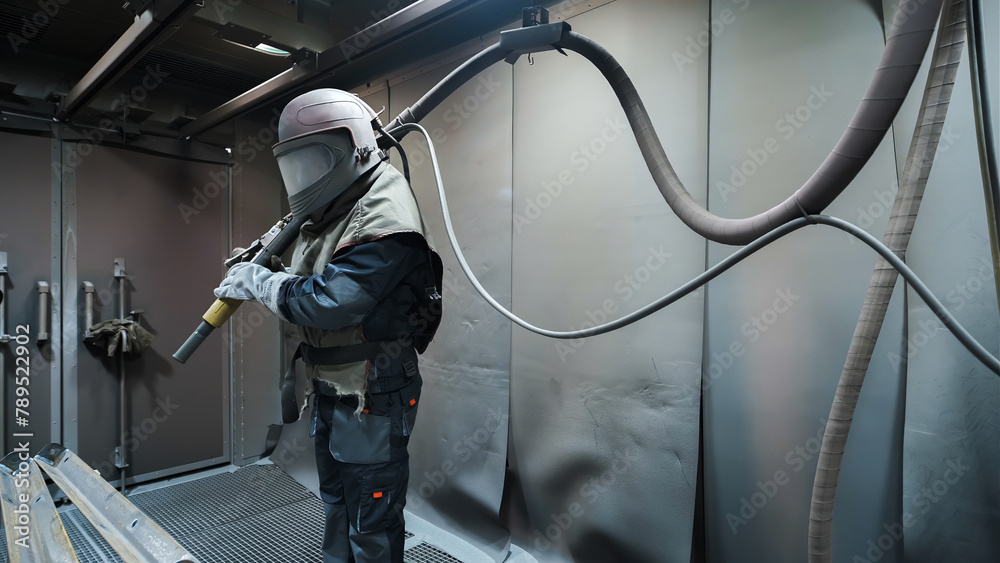 shot blasting man in production, The sandblaster is sending to steel ...