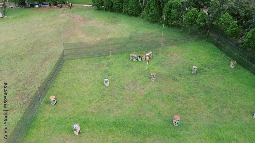 Bird's-eye view video of a paintball arena, revealing strategic ...