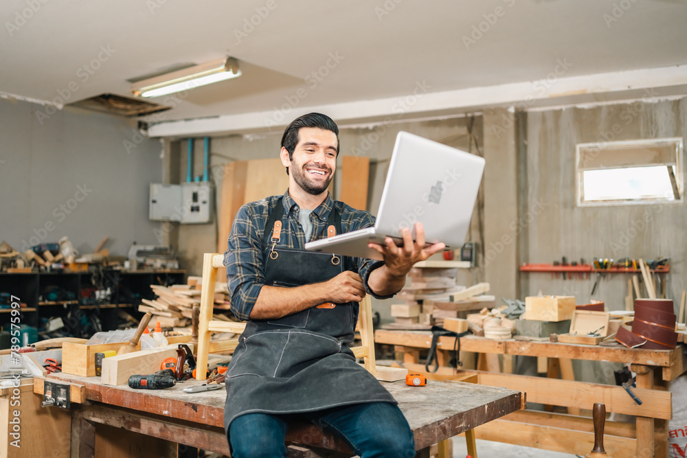Diligently skilled man work with wood in carpenter's shop, using tools ...