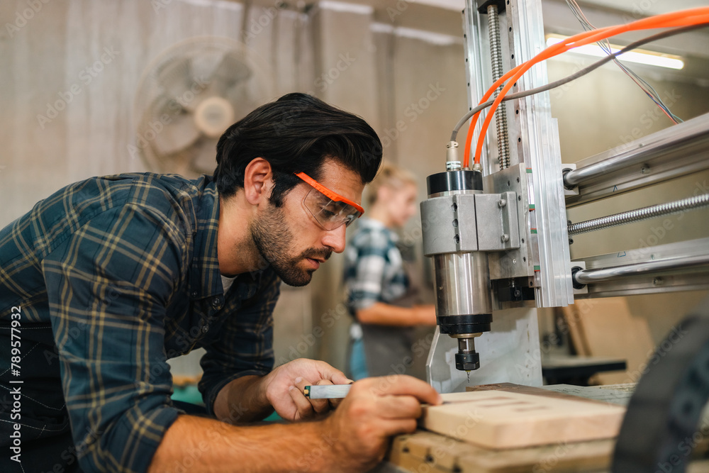 Diligently skilled man work with wood in carpenter's shop, using tools ...