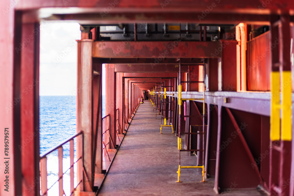 Cargo container ship deck walkway, under loaded containers with cargo ...