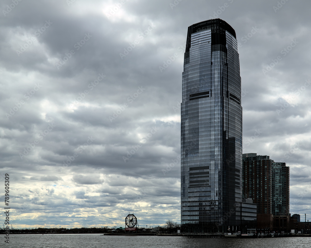 tall jersey city building detail against dark gray sky (skycraper, city ...