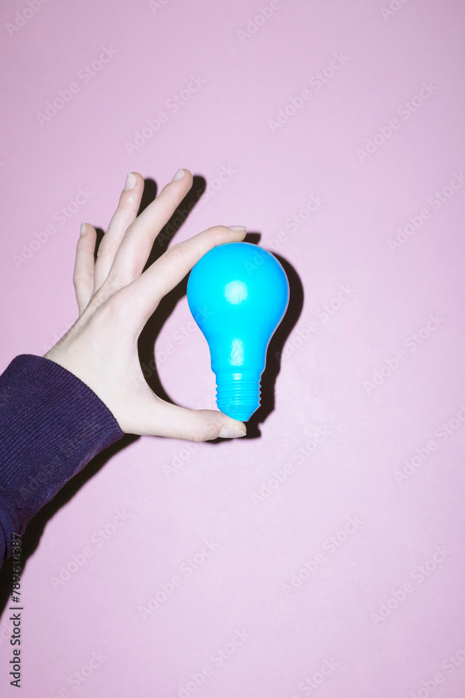 Hand holding light bulb representing new idea, ideation, eureka Stock ...