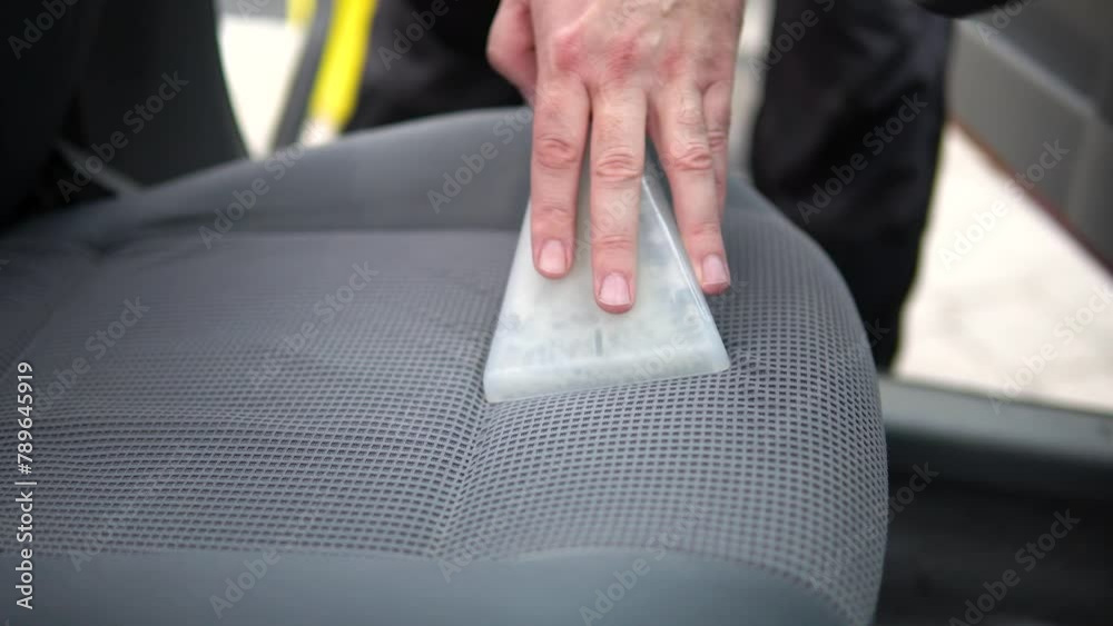 Car cleaning detailing - male using professional steam vacuum chemical ...