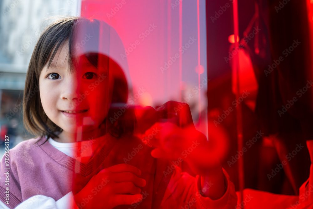 Cute little girl portrait with red glass Stock Photo | Adobe Stock
