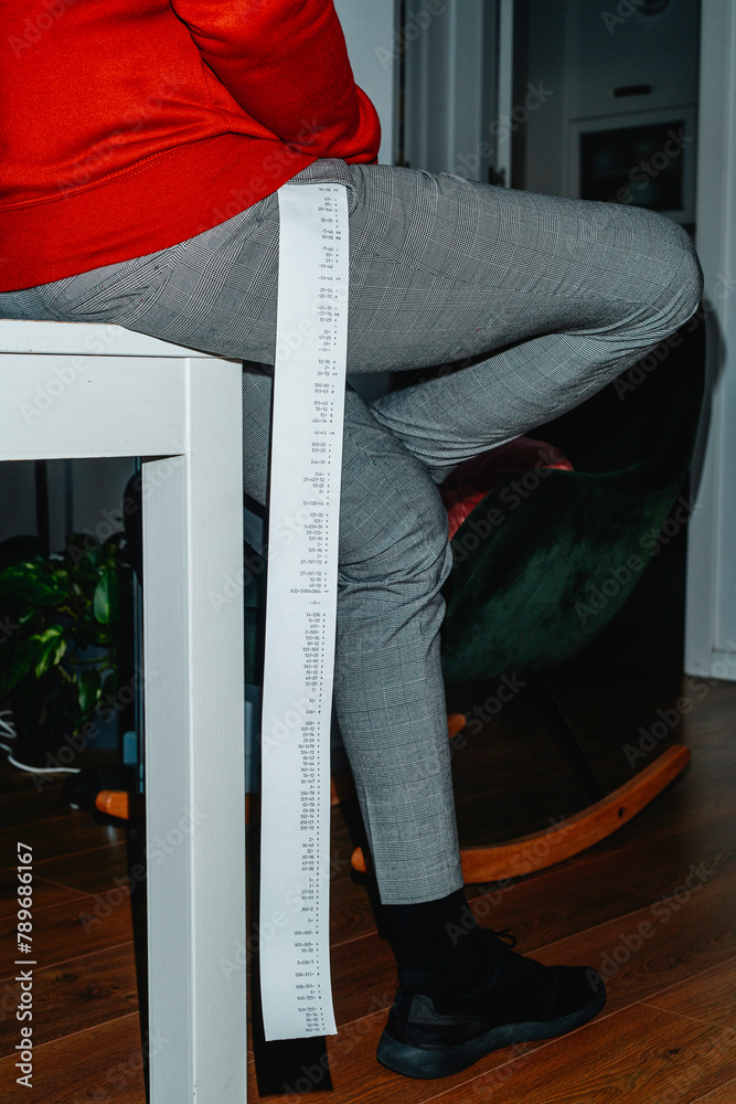 man with a long strip of paper with different calculations Stock Photo ...