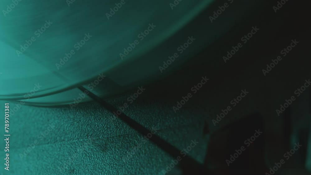 Extreme close-up view of spinning spool of vintage reel-to-reel tape ...