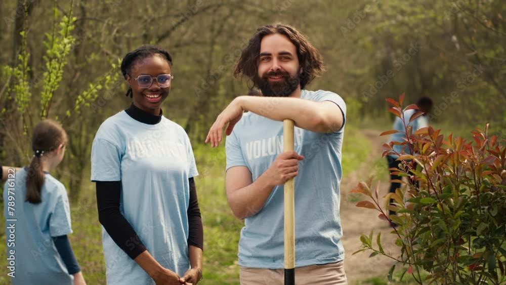 Portrait of diverse activists team tidying natural environment by ...