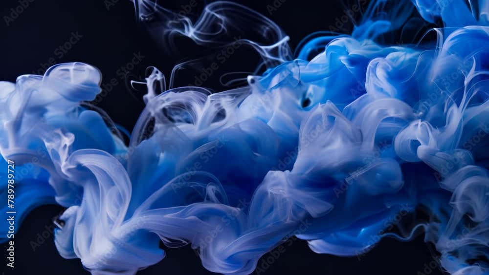 Bluish-white smoke swirls and flows, spreading across a black ...