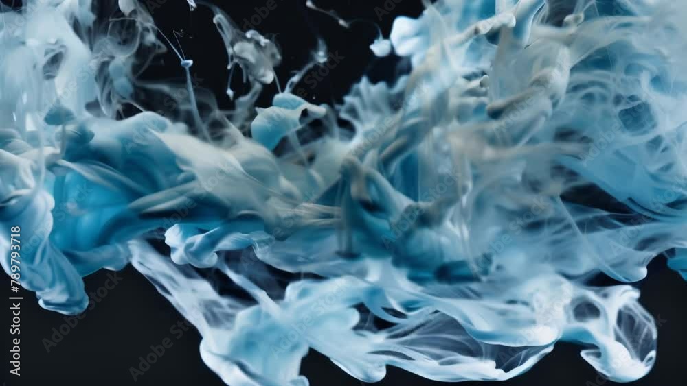 Bluish-white smoke swirls and flows, spreading across a black ...