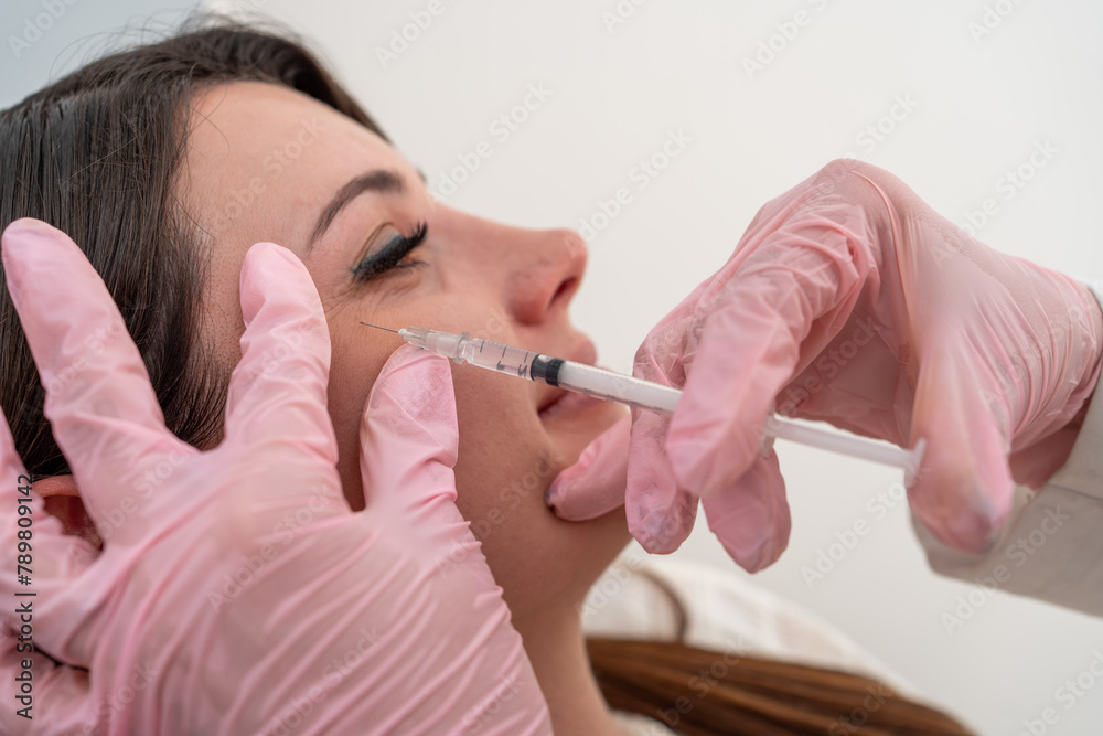 Beautician injecting Botox for eye wrinkle rejuvenation, targeting crow ...