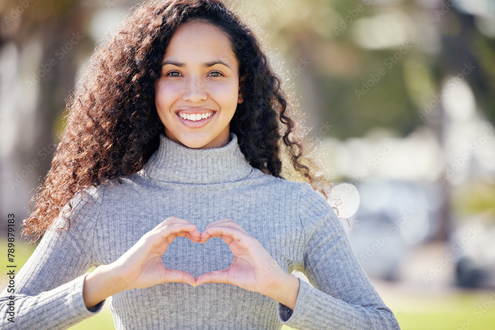 Portrait, heart sign and woman in park, support and outdoor with symbol ...