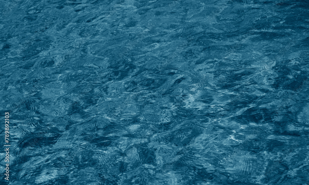 fountain water texture with solar patches of light. refreshing blue ...