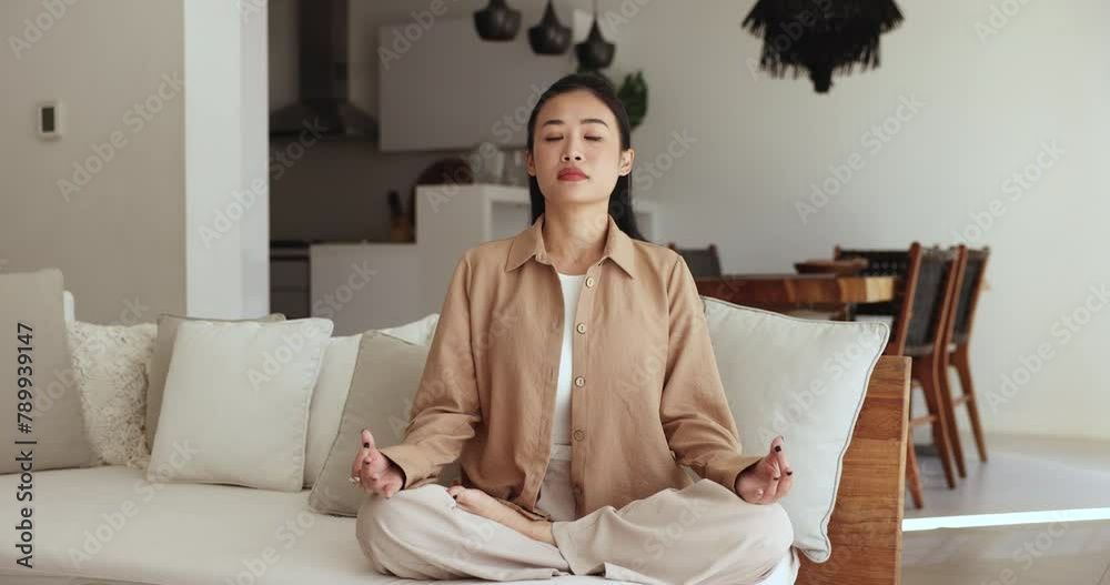 Woman meditate sit on sofa in lotus position with eyes closed. Female ...