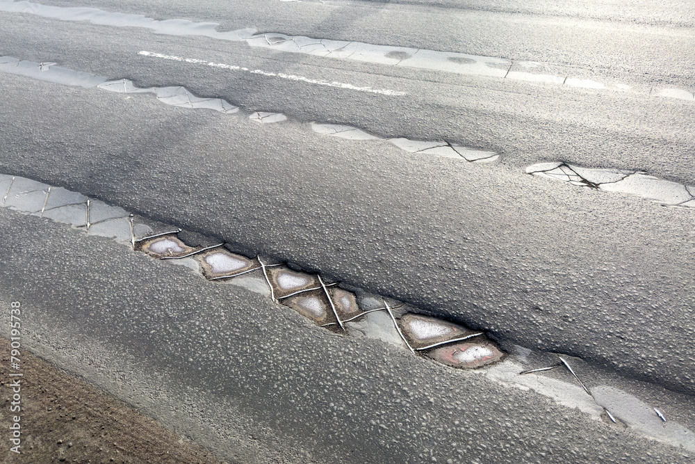 Rutting on poor asphalt road on bridge in the city, low-quality asphalt ...