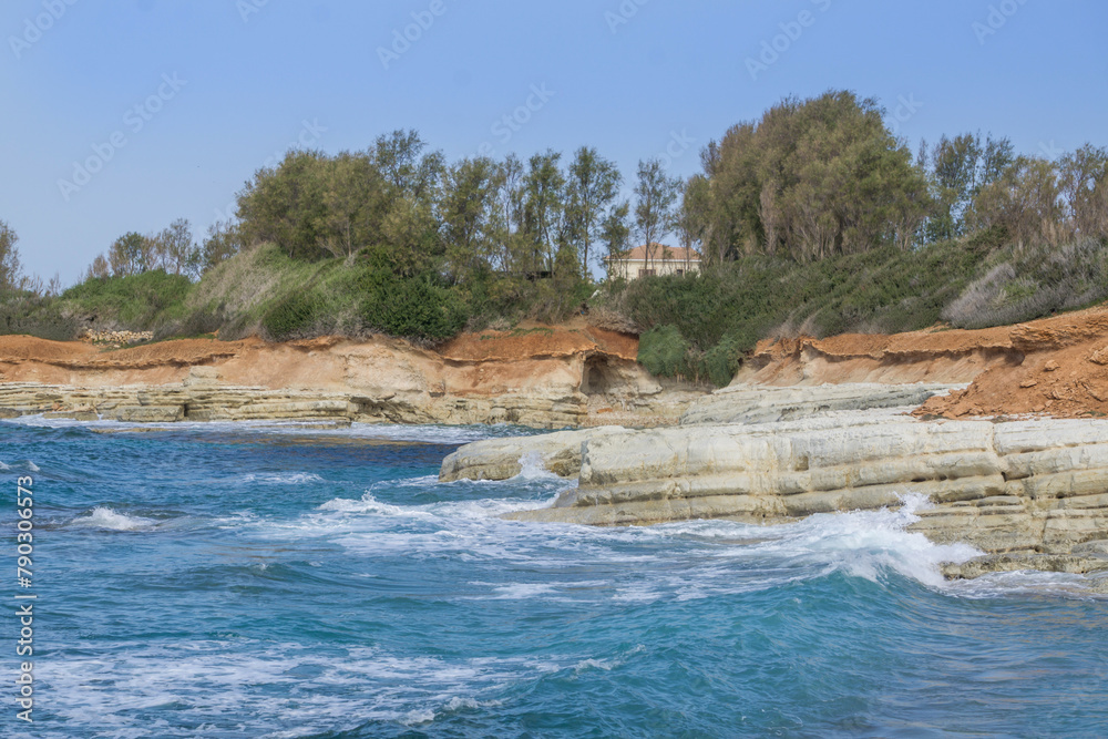 Rocky Shoreline Next to Water. A rocky shore meets a body of sea, with ...
