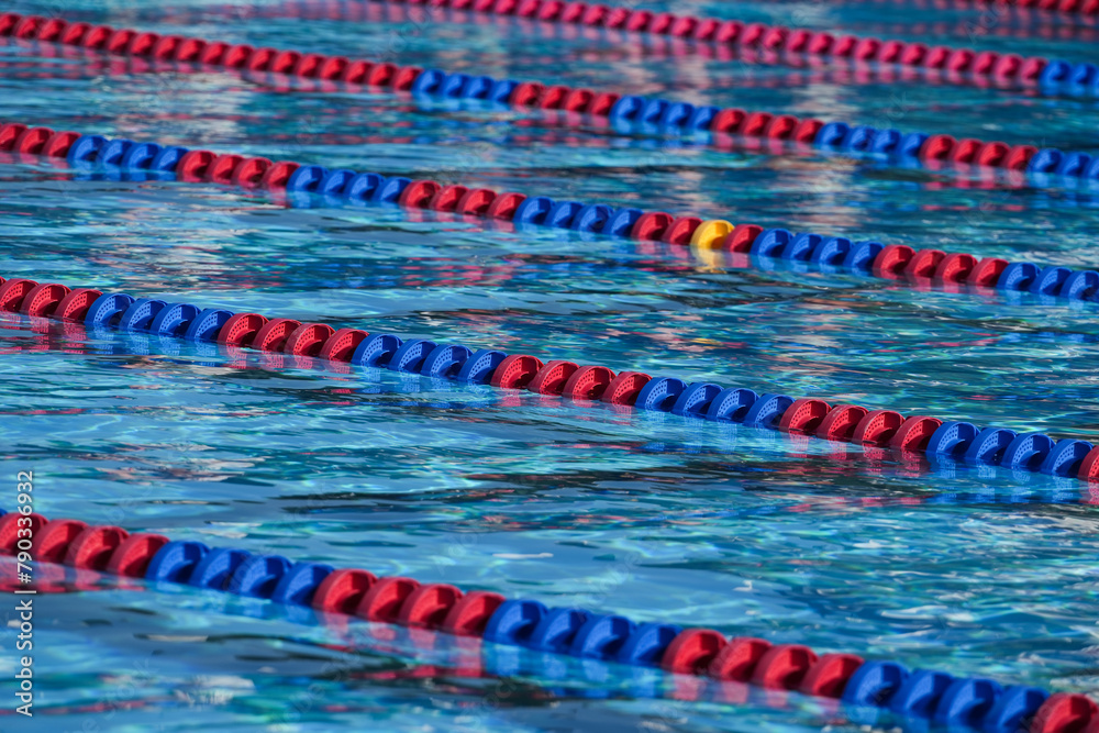 blue and red competitive swimming lane lines at an outdoor pool Stock ...