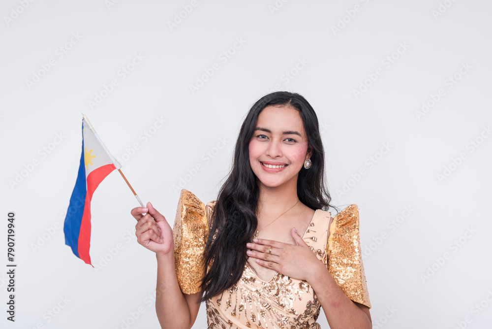 Filipino woman in traditional Filipiniana dress holding Philippine flag ...