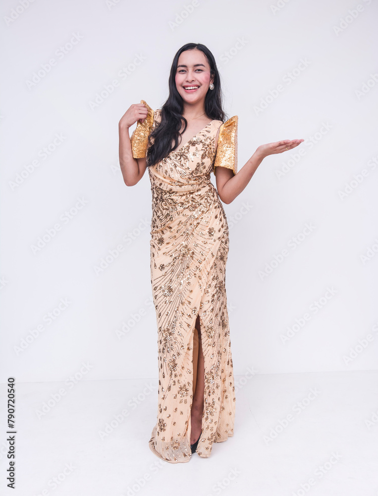 Elegant Filipino woman in gold Filipiniana dress presenting with ...