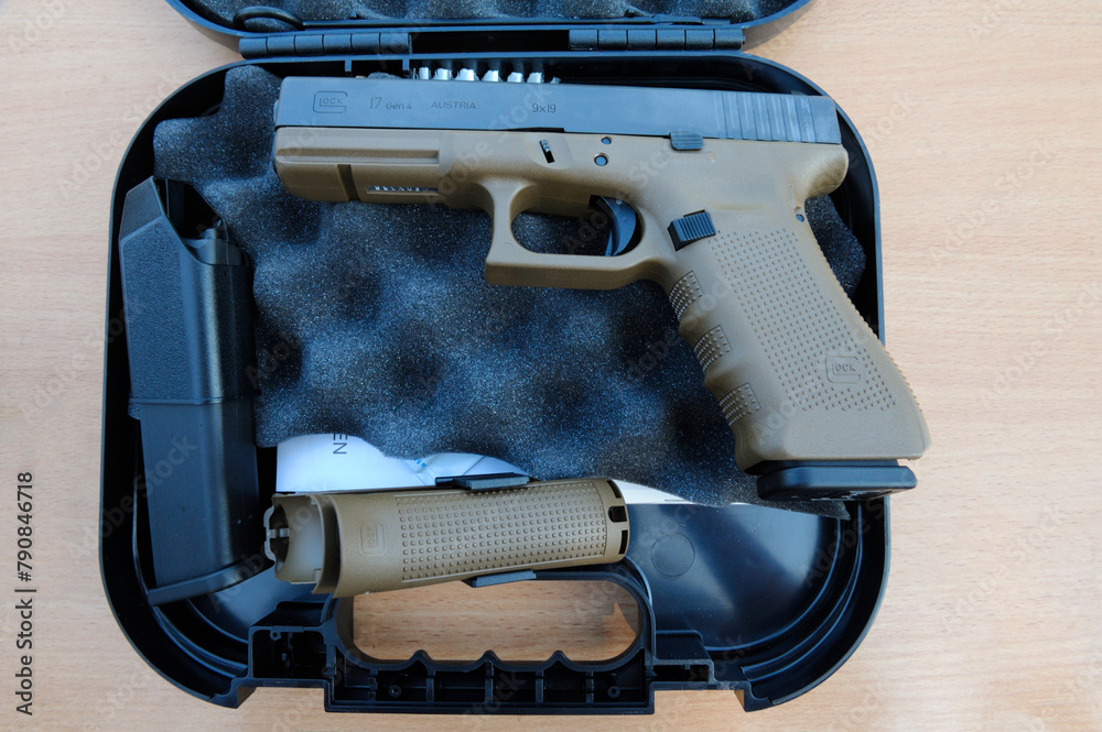 Fire-Arm Glock placed on a box. This type of pistol is in use of ...