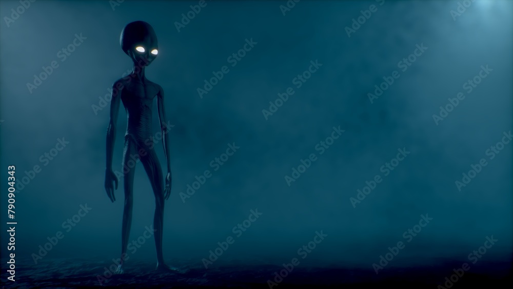 Scary gray alien stands and looks blinking on a dark smoky background ...