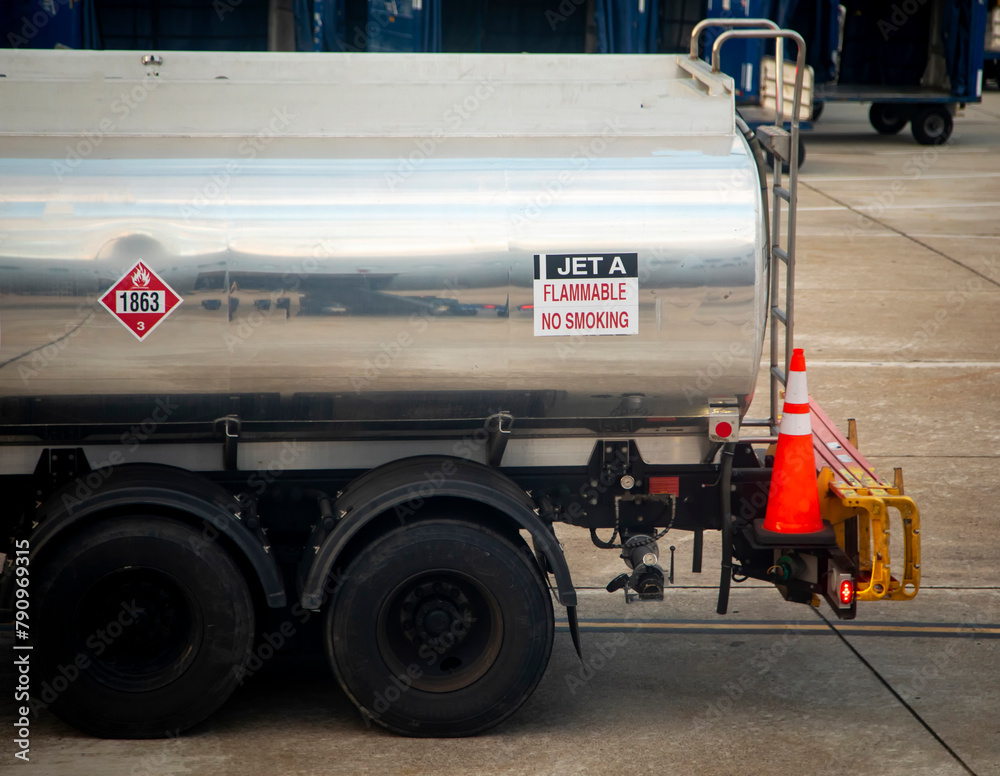 Silver tanker at an airport carrying type A 1 jet fuel. There is also a ...