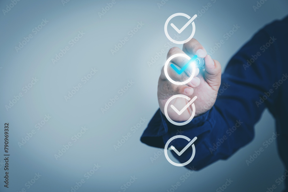Businessman touching on the mark in the checkbox for quality document ...