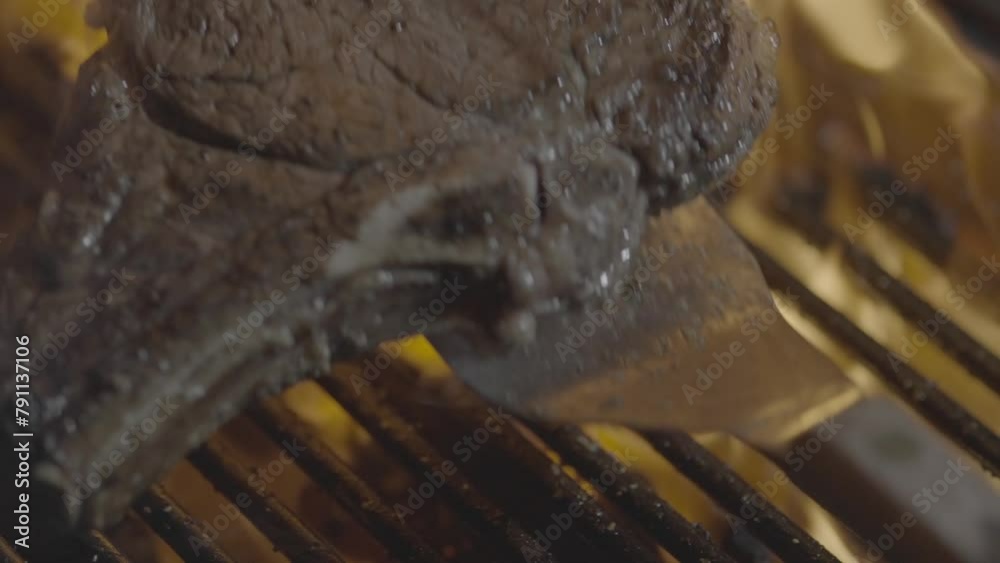 Roast beef with fire flames. Beef steak on grill with flames. Rib-eye ...