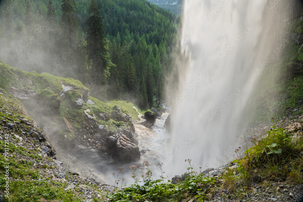 waterfall flow.Streams of water crash on rocks and boulders. stormy ...