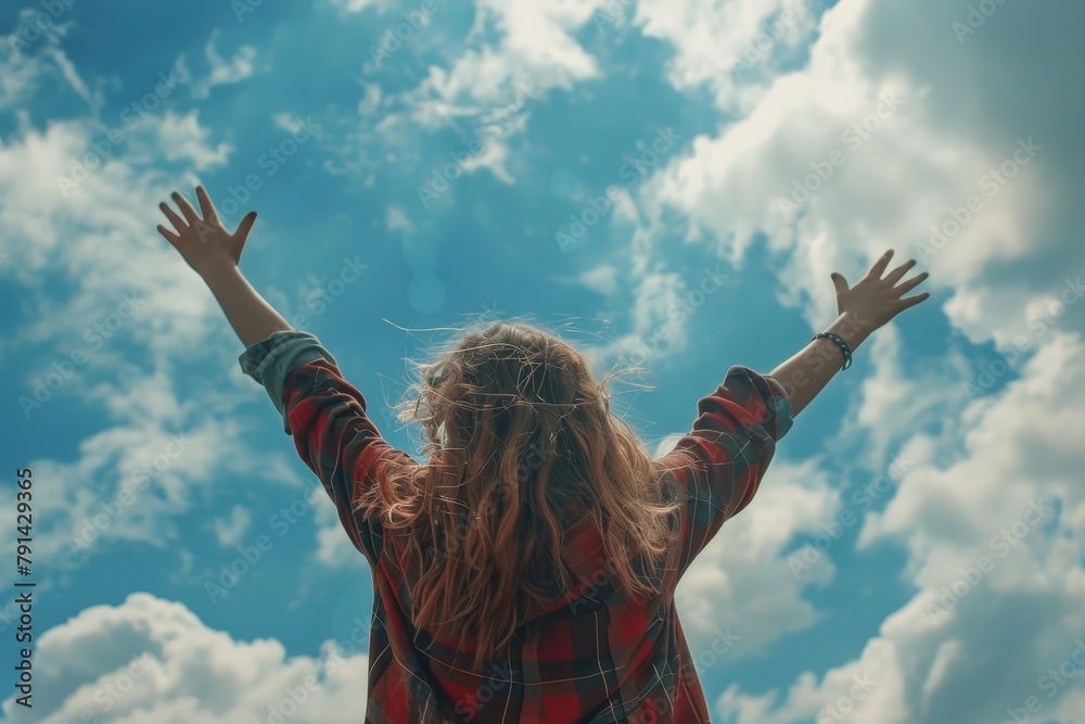 Back view of a Girl lift her hands to the sky and feel freedom outdoor ...