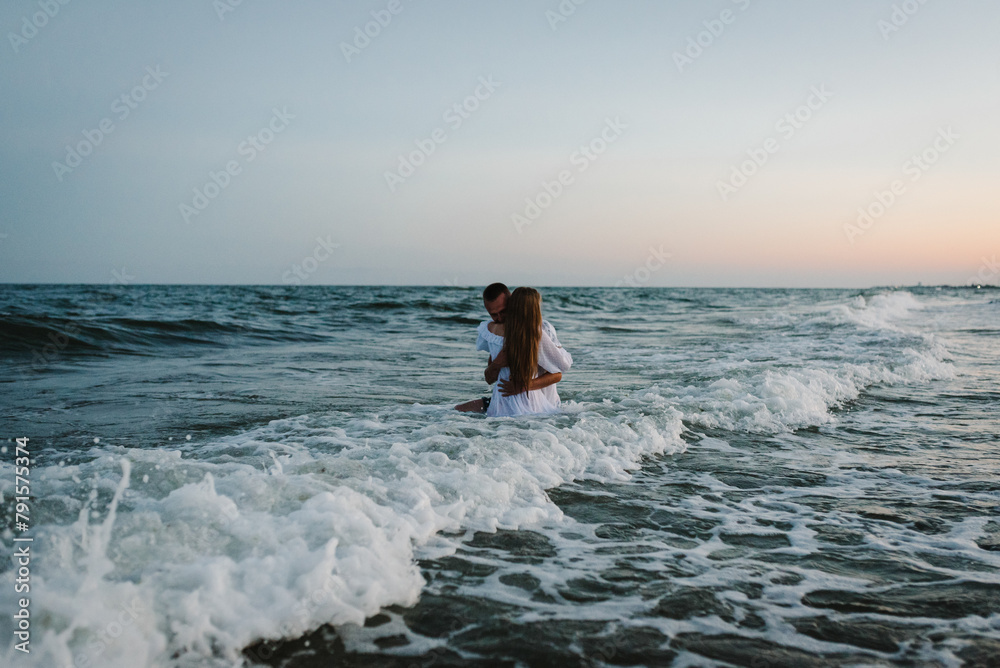 Swimming. Portrait of a beautiful man and woman in wet clothes in sea ...