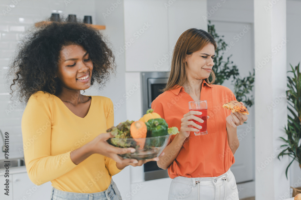 Two women choosing between vegetable and sausage, organic food vs gmo ...