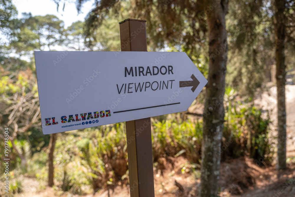 Sign in English and Spanish viewpoint and direction arrow on a trail in ...
