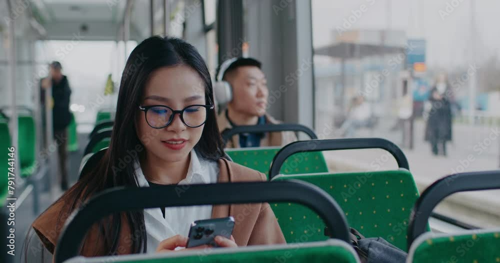 Camera view of beautiful Chinese girl sitting inside bus or train ...