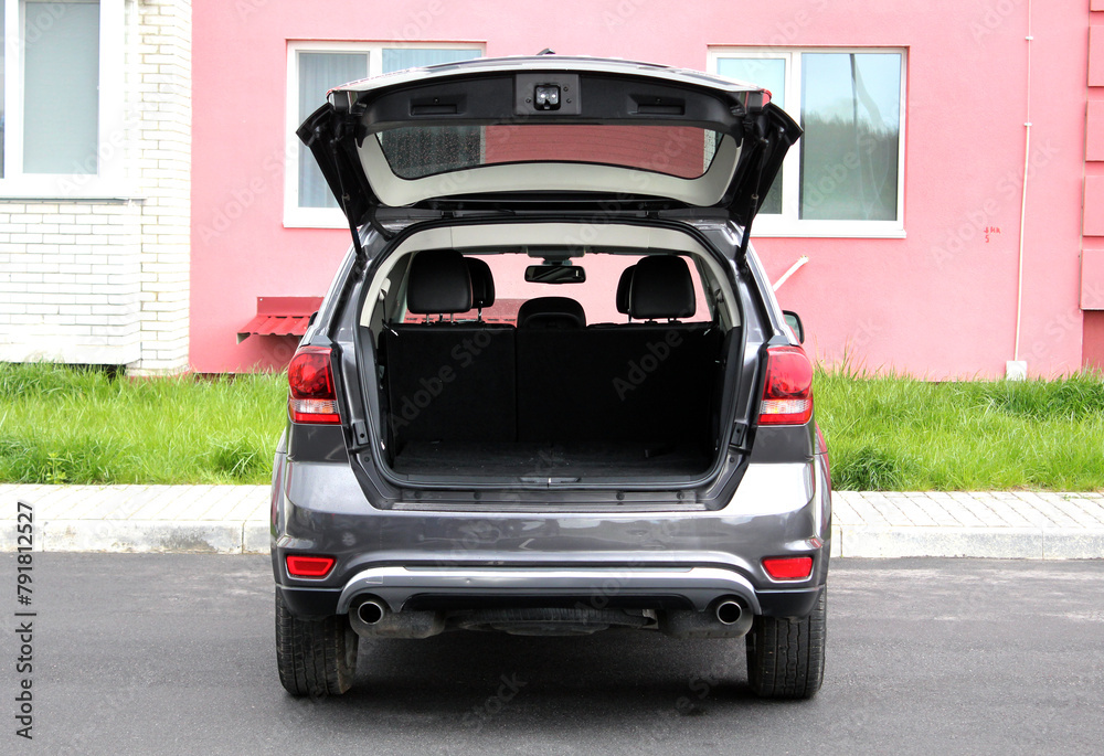Crey car is ready to load luggage. Clean trunk wagon car. Modern SUV ...