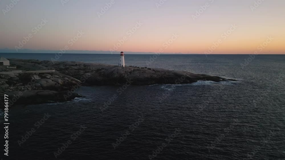 Sun dips below horizon, casting a warm golden glow across the rugged ...