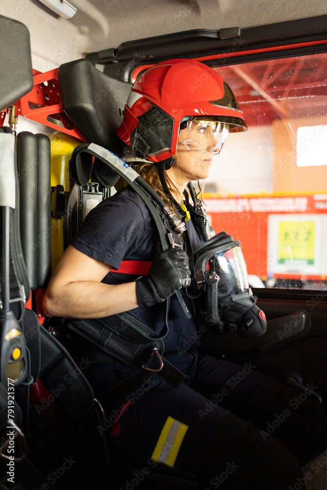 A woman in her 40s and 50s works as a firefighter in uniform.The adult ...