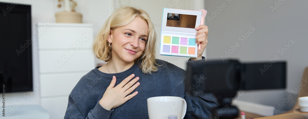Lifestyle blogger, records video in her room, has a camera on coffee ...