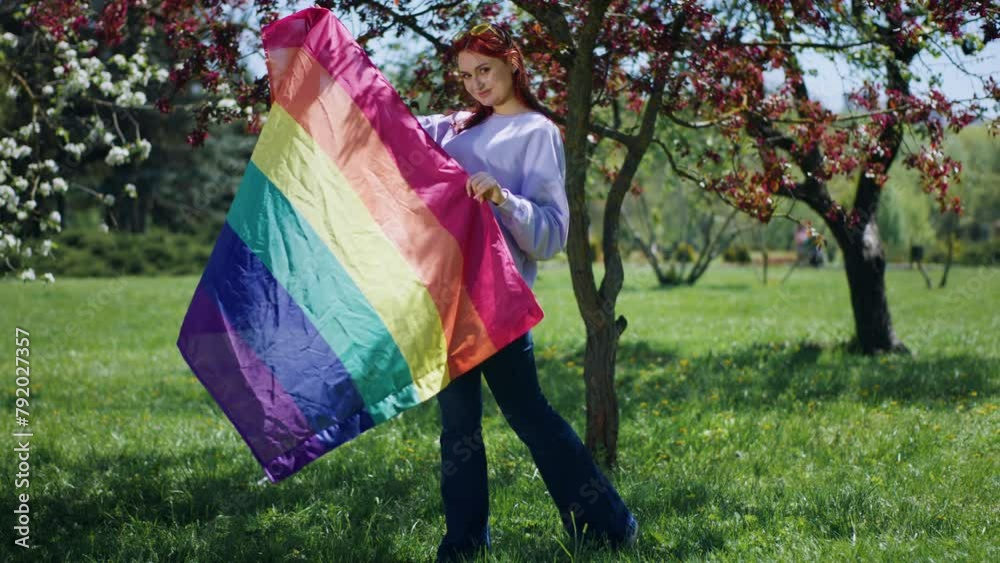 In front of the camera in the middle of the park lgbt lady with red ...