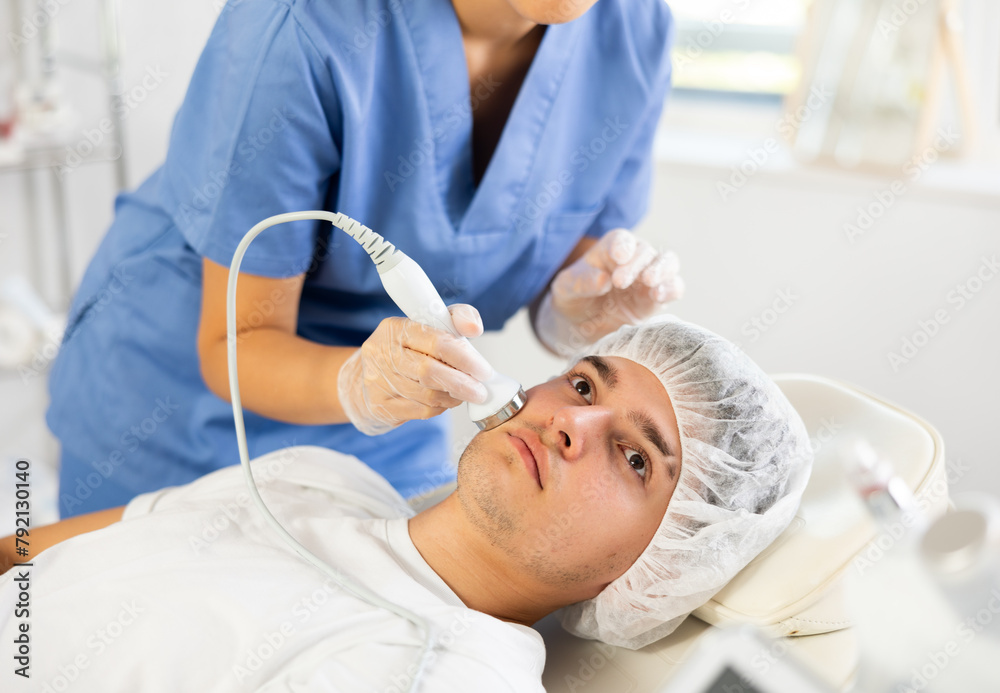 Experienced female cosmetic doctor carefully performs procedure on her ...