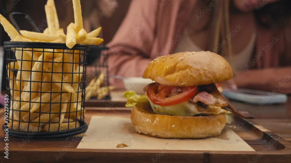 Restaurant close-up fast food juicy burger golden-brown french fries ...