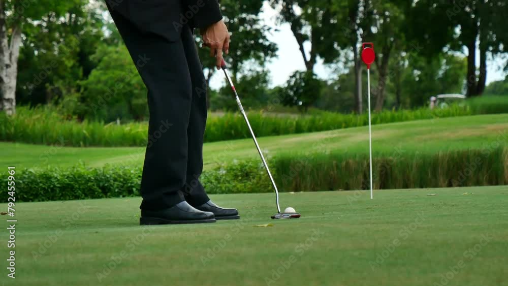 Businessman playing Golf ball practice hit swing on tee in golf club ...
