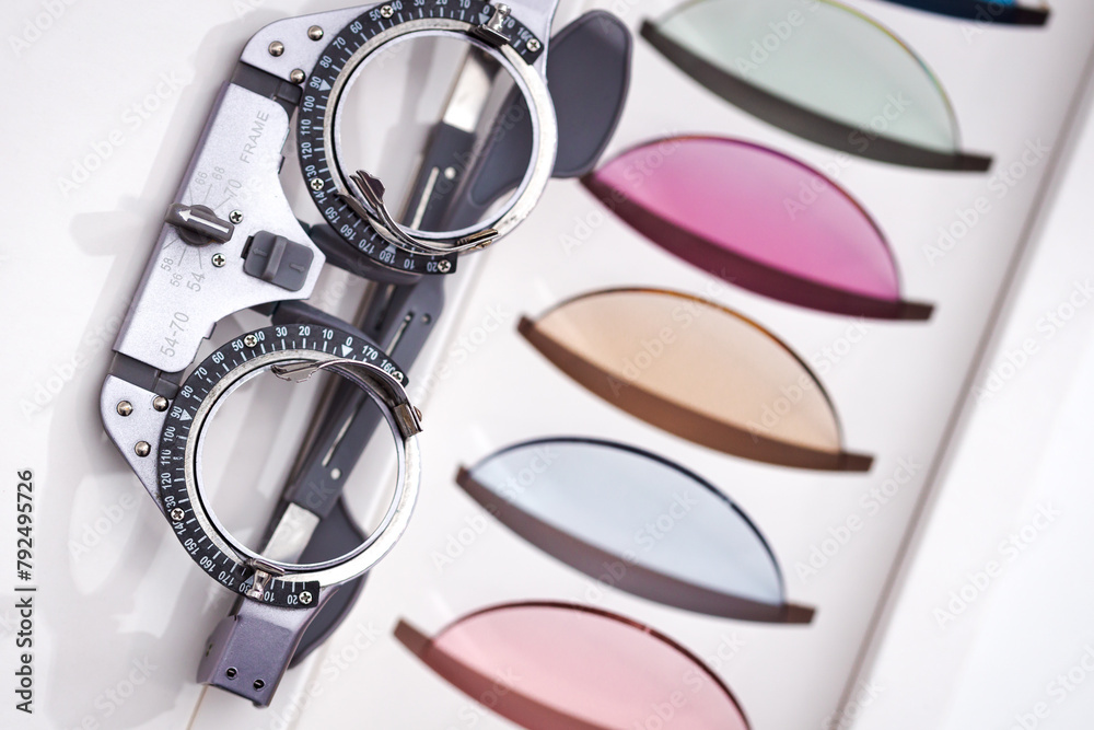 Eye test frame for optician with many different colored trial lenses ...
