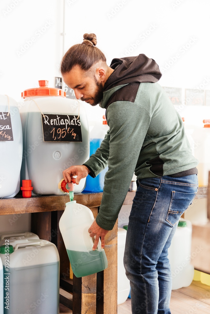 Man Refilling Container at Zero-Waste Grocery Store With Eco-Friendly ...