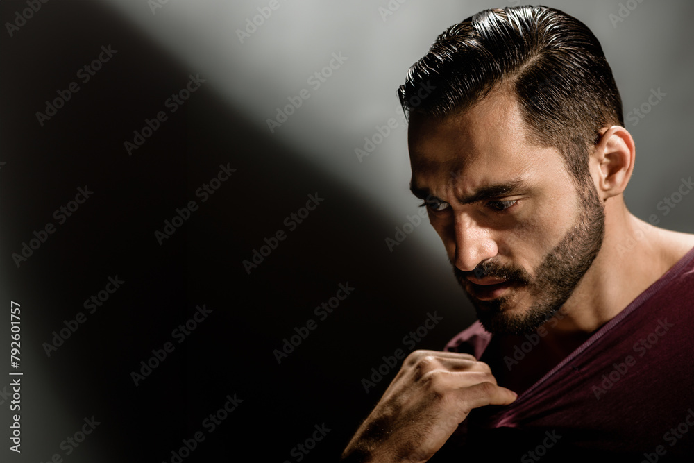 Portrait of self confident brutal minded man on dark dramatic ...