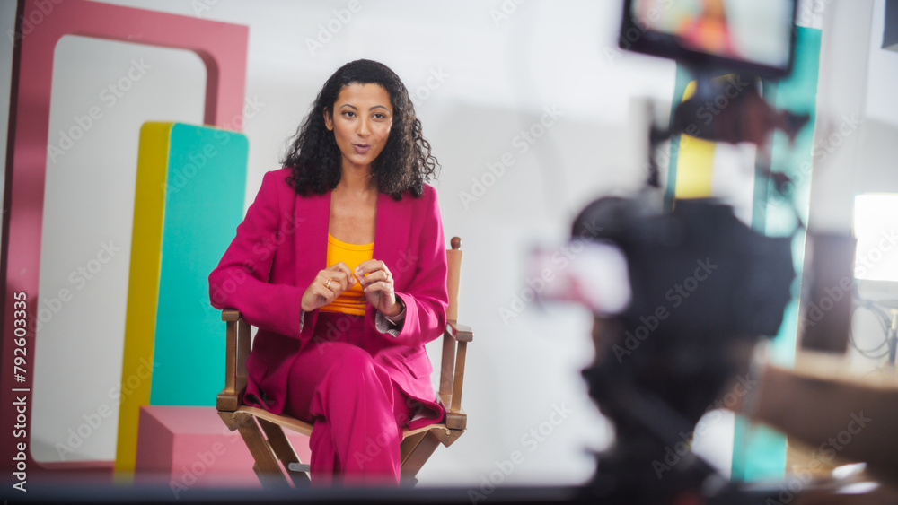 Young Black Female Host In Vibrant Pink Suit Engaged In Lively ...